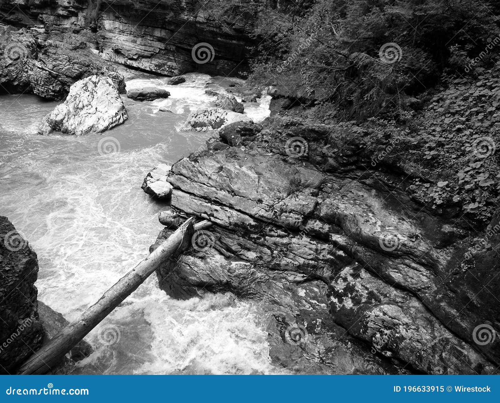 Greyscale High Angle Shot of a River Flowing among the Rocks and Cliffs ...