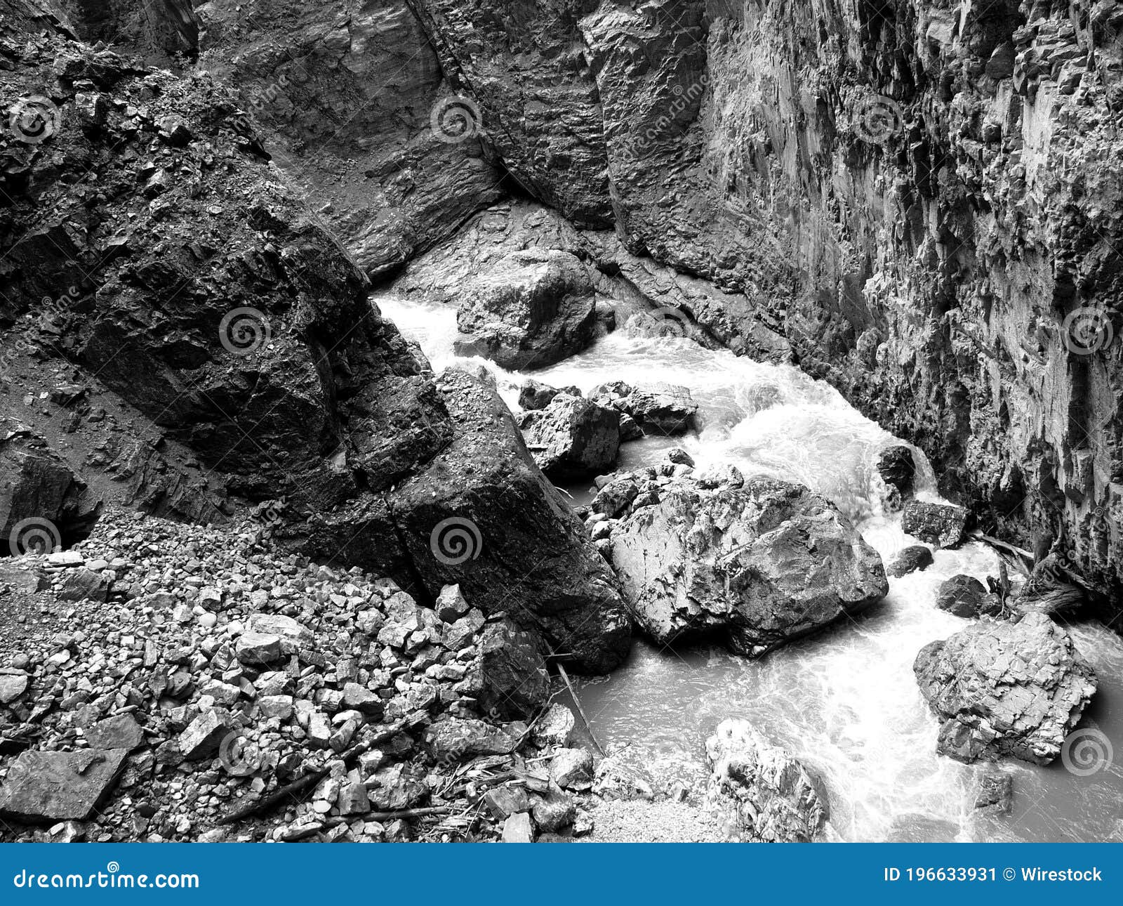 Greyscale High Angle Shot of a River Flowing among the Rocks and Cliffs ...