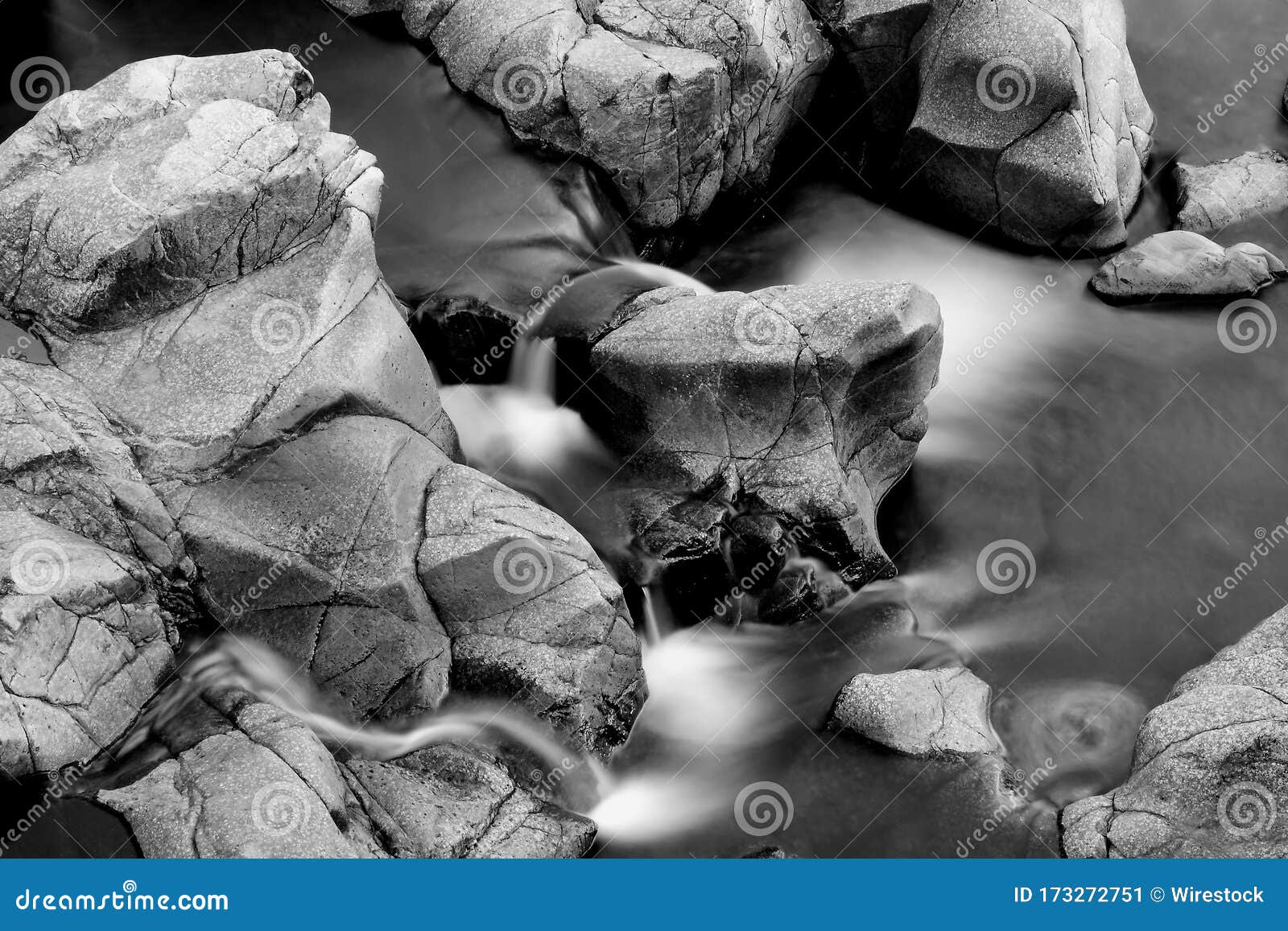 Greyscale of a River Covered in Granite Boulders Under the Sunlight in ...