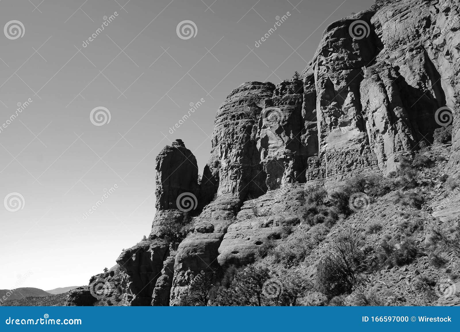 Greyscale of Rocks Covered in Grass with Blurry Hills on the Background ...
