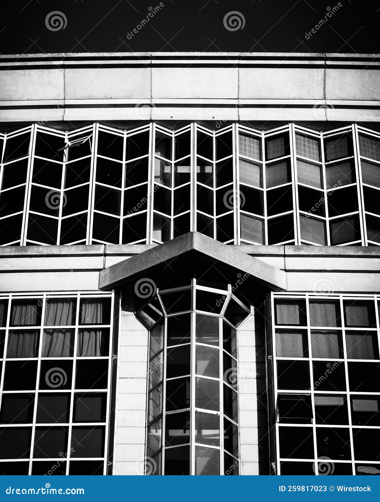 Greyscale Shot of a Modern Building with Glass Wall Stock Image - Image ...