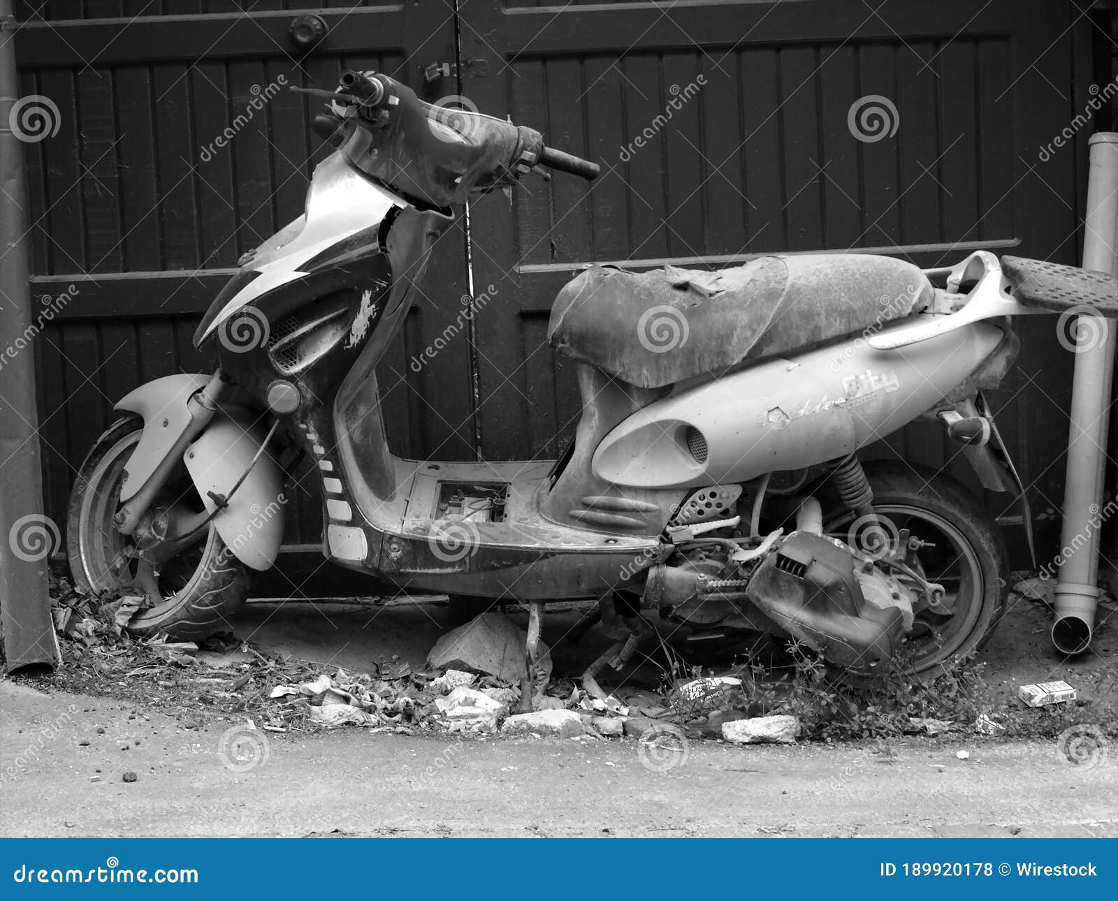 Greyscale Shot of an Old and Abandoned Motorcycle in the Garbage ...