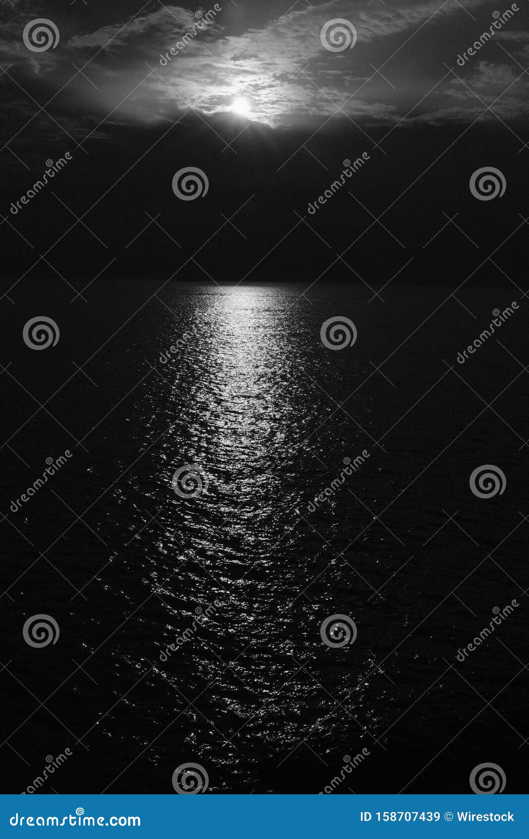 Greyscale Shot of the Sunset, with the Reflection of the Sun Rays in ...