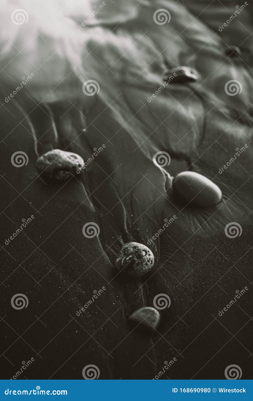 Greyscale of Stones on the Beach Surrounded by the Sea Under Sunlight ...