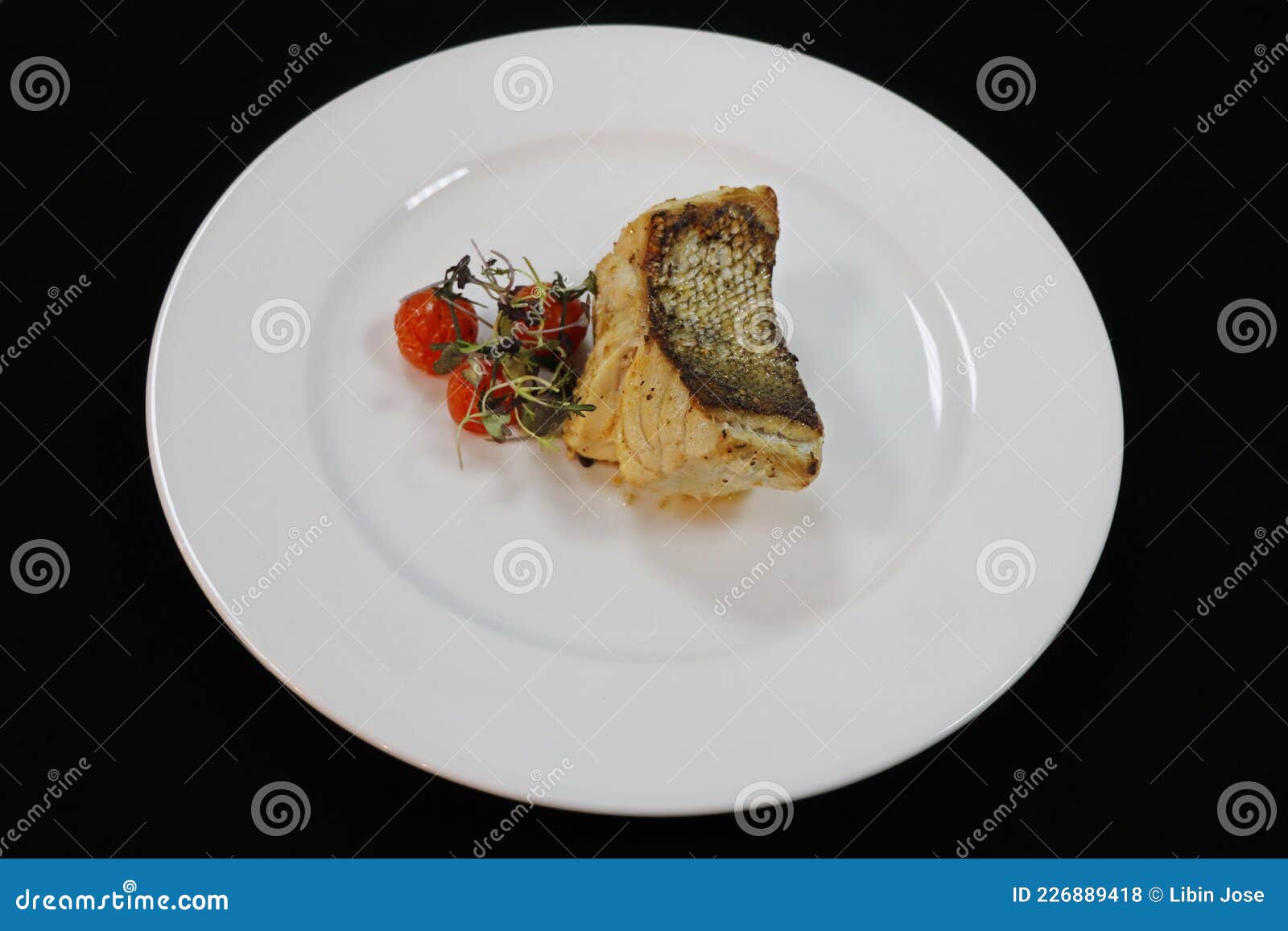Grilled Atlantic Cod Fish Fillet on a White Plate with Cherry Tomato ...