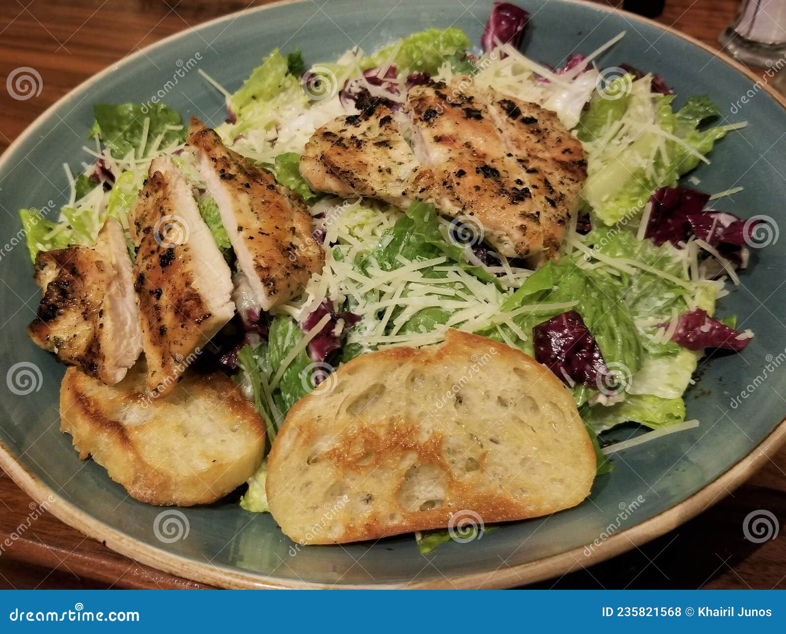 Grilled Chicken Caesar Salad with Garlic Bread Served on a Green ...