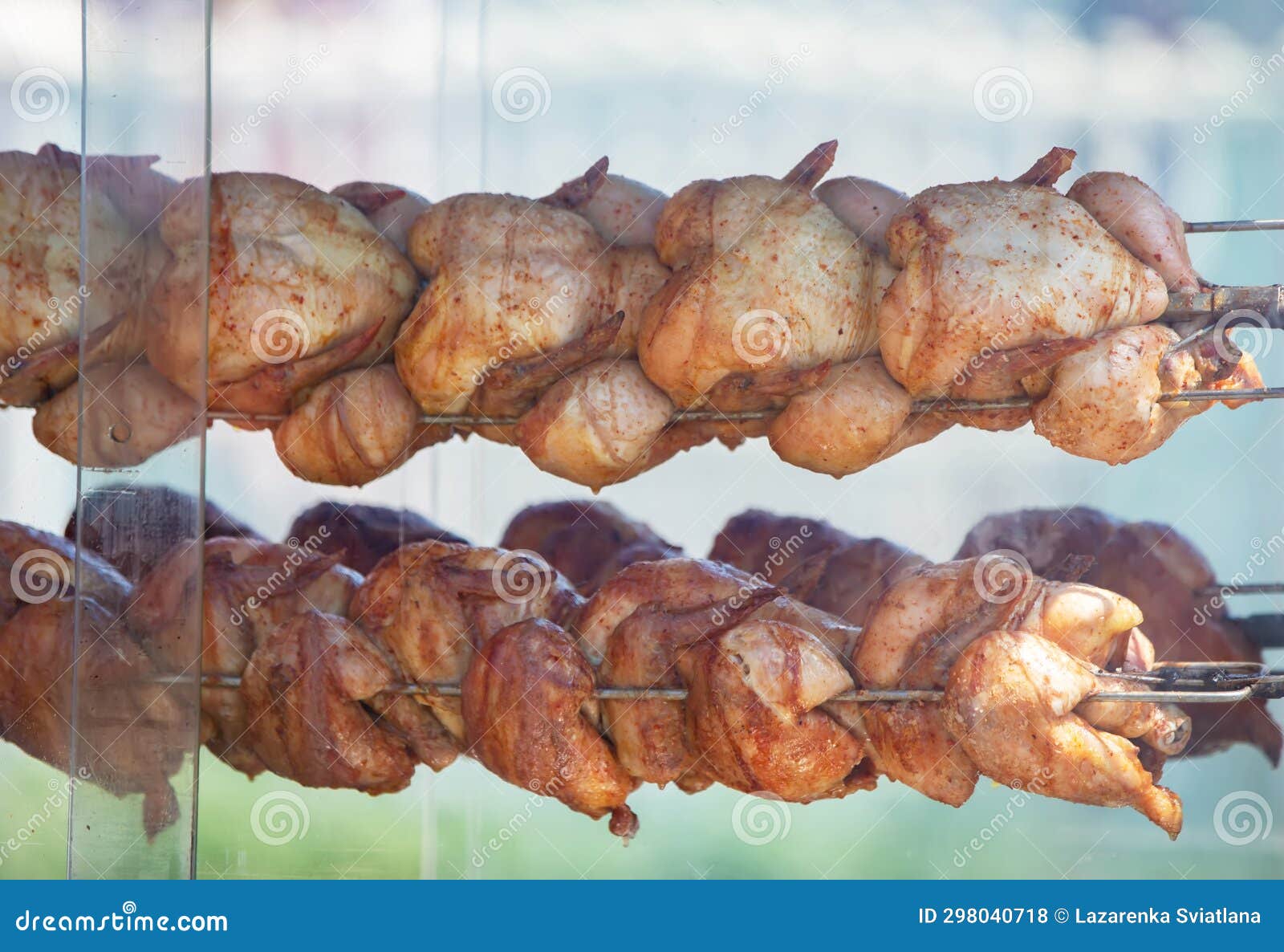 Grilled chicken on a spit stock photo. Image of cooked - 298040718