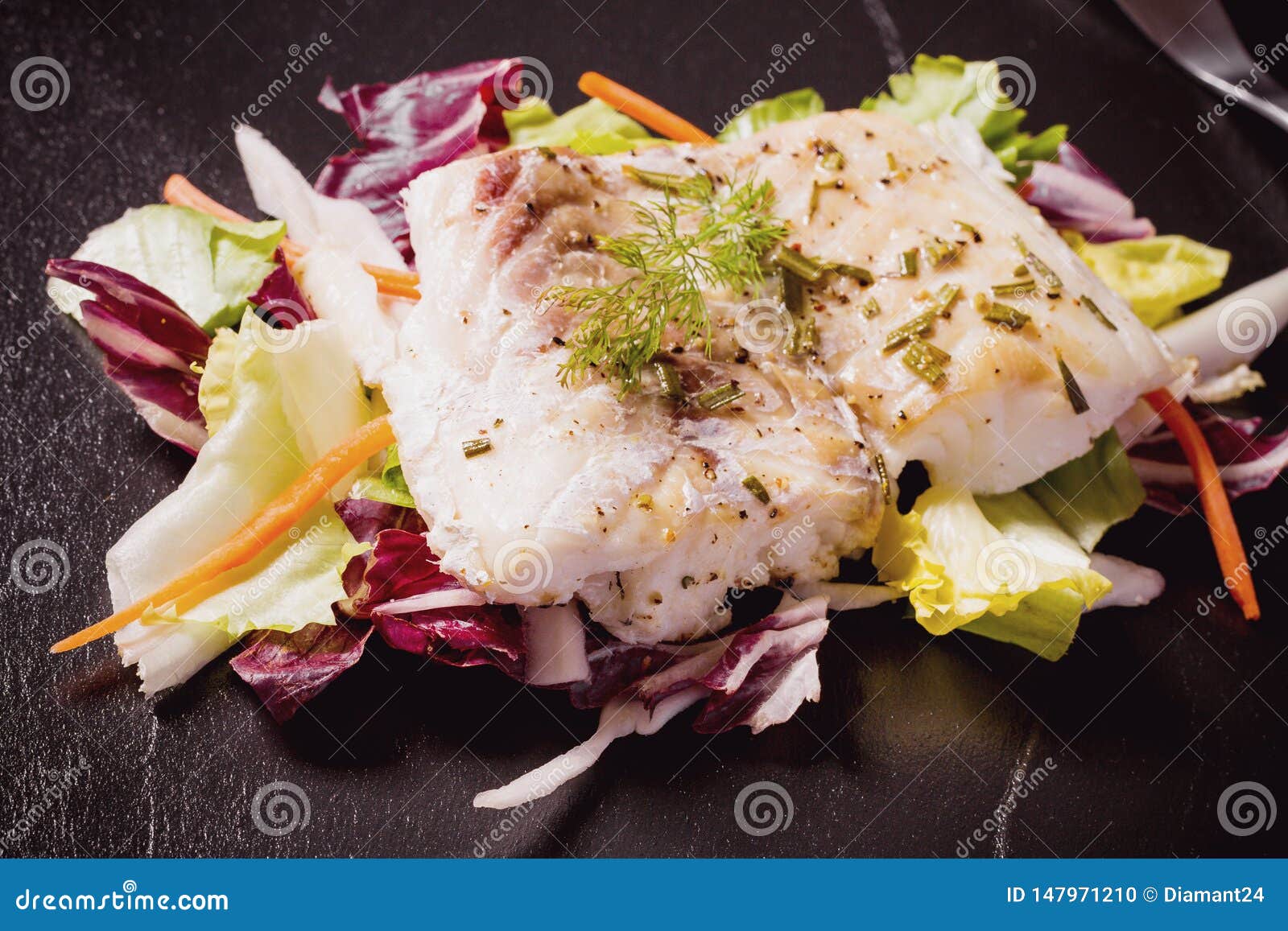 Grilled Cod Fillet with Salad on Black Slate Plate Stock Photo - Image ...