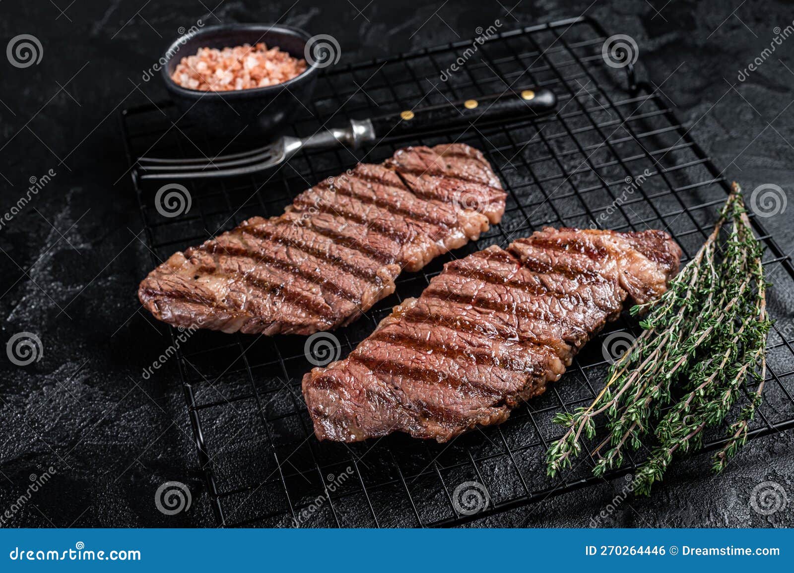Grilled Denver Beef Meat Steak on a Rack. Black Background Stock Photo ...