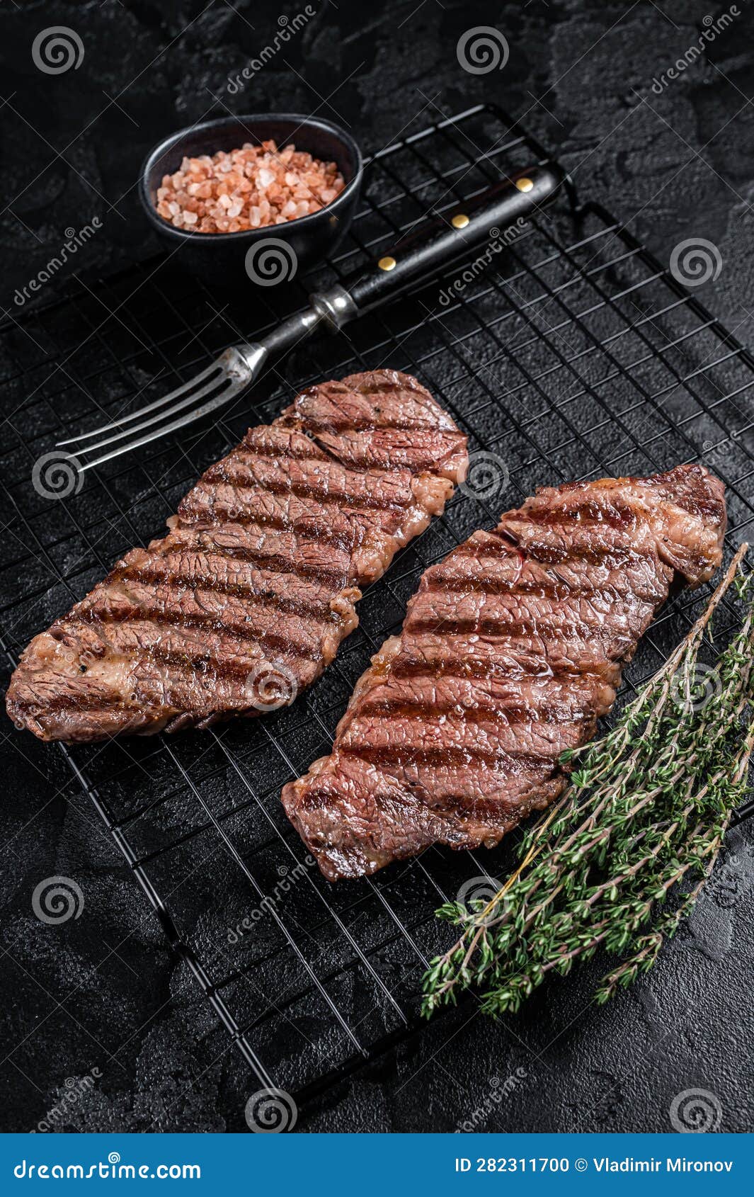 Grilled Denver Beef Meat Steak on a Rack. Black Background Stock Photo ...