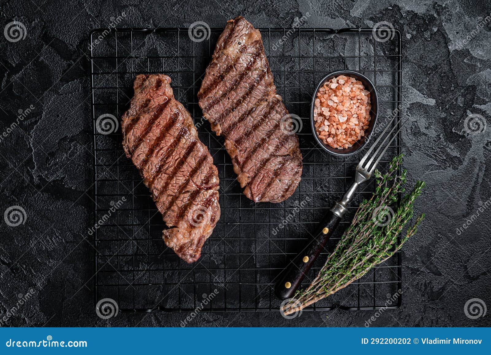 Grilled Denver Beef Meat Steak on a Rack. Black Background Stock Photo ...