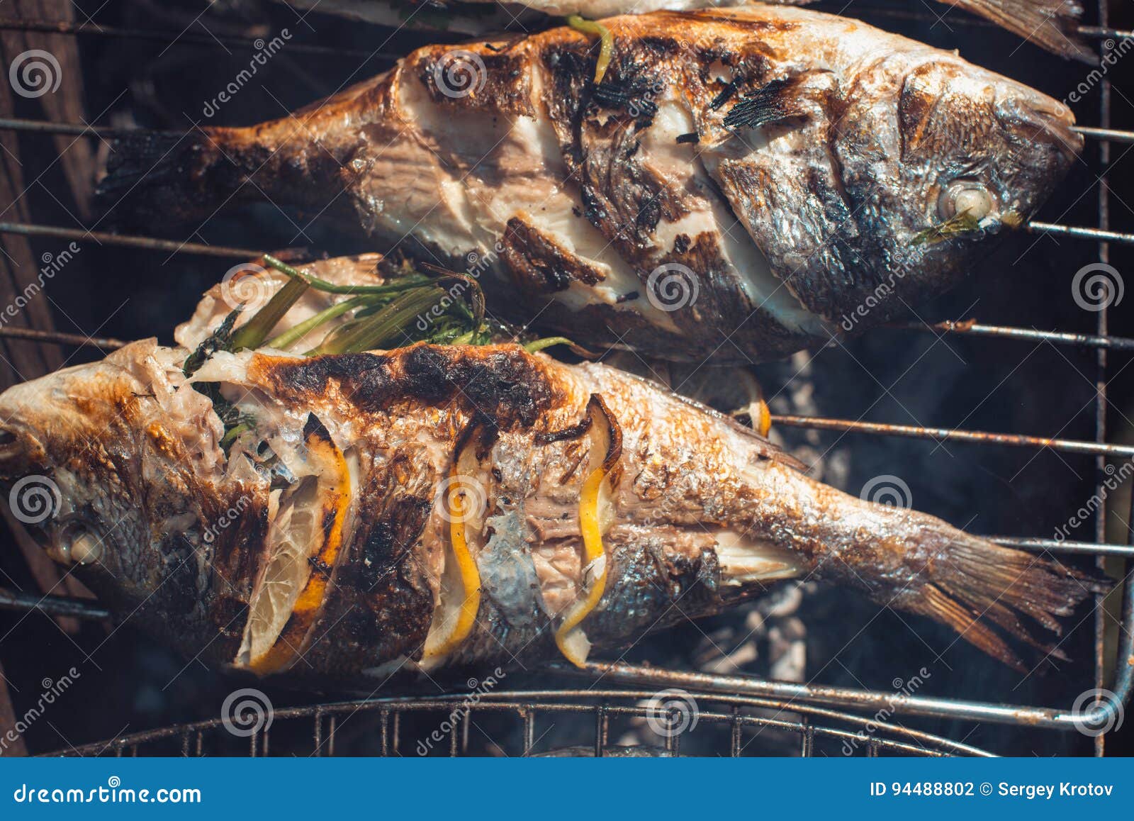 Grilled Fish with Lemon on the Grid Barbeque in the Garden in Summer ...