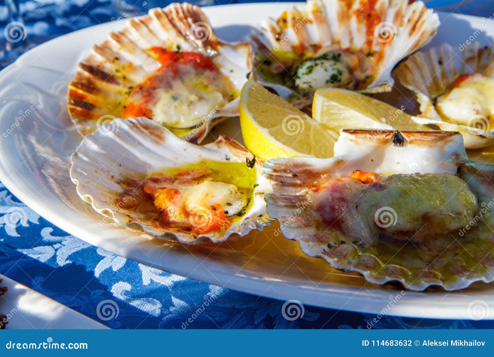 Grilled Fresh Scallop on Shell and Lemon on the Plate Stock Photo ...