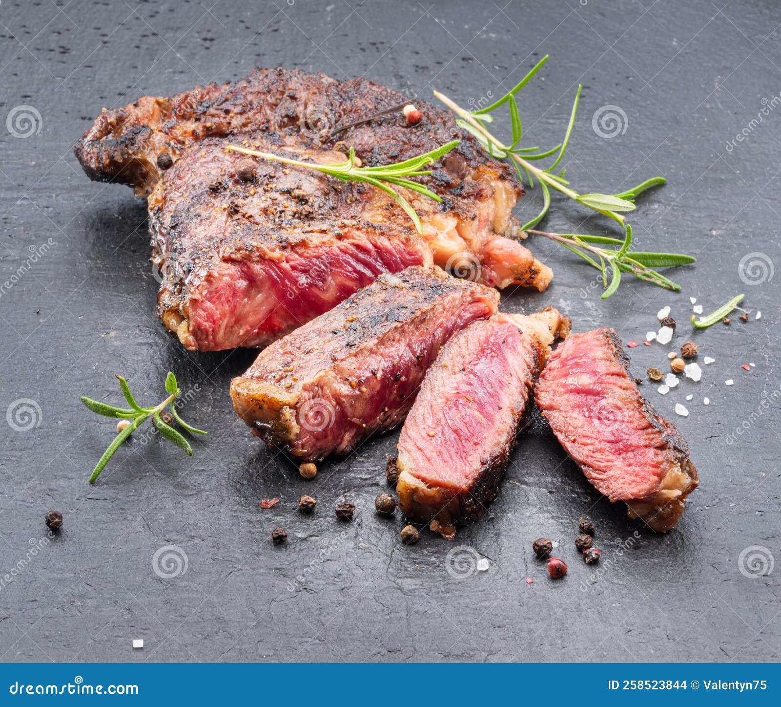 Grilled Medium Rare Ribeye Steak on Gray Stone Plate Stock Photo ...