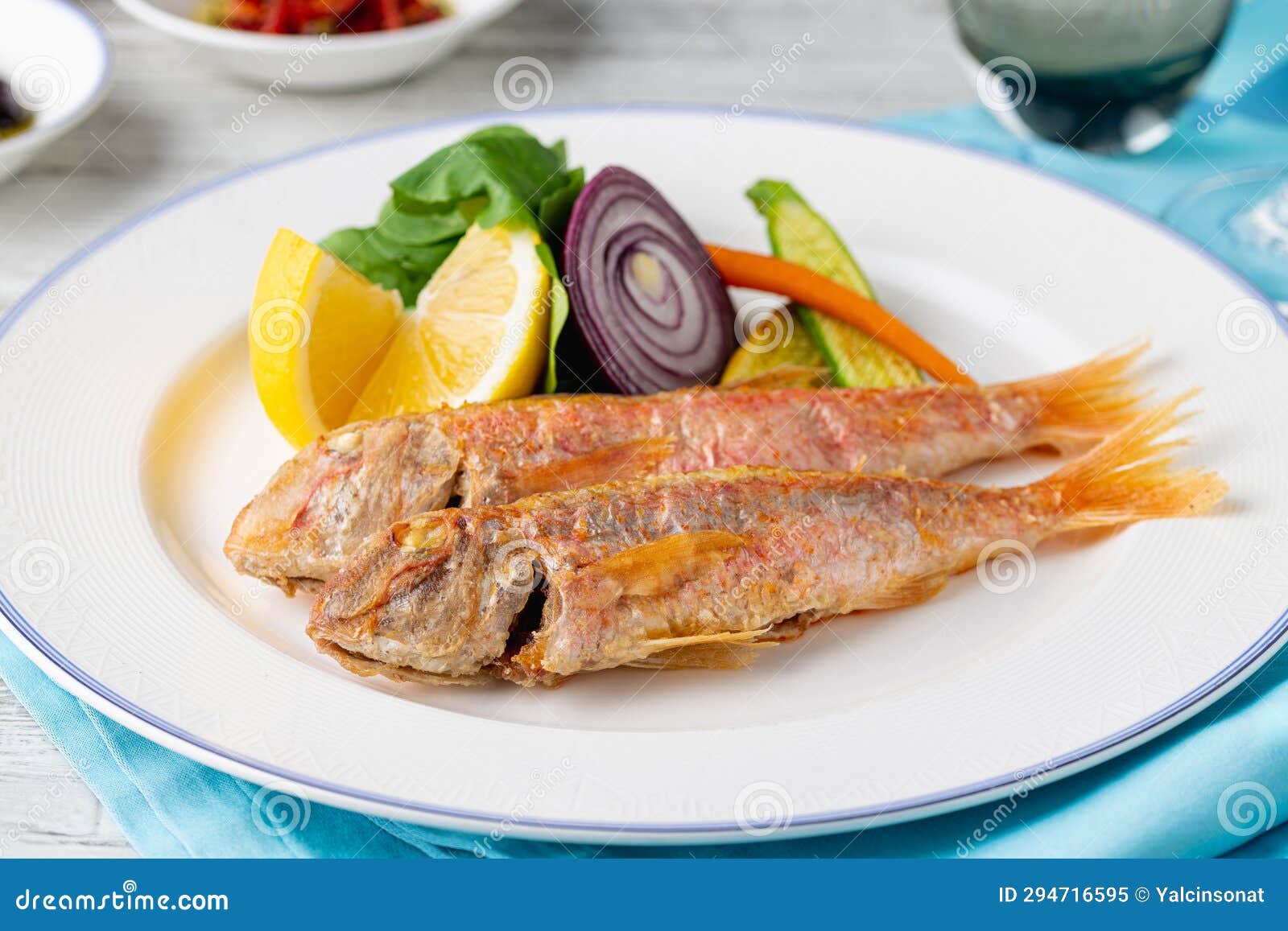 Grilled Mullet Fish with Arugula and Mini Vegetables on a White ...
