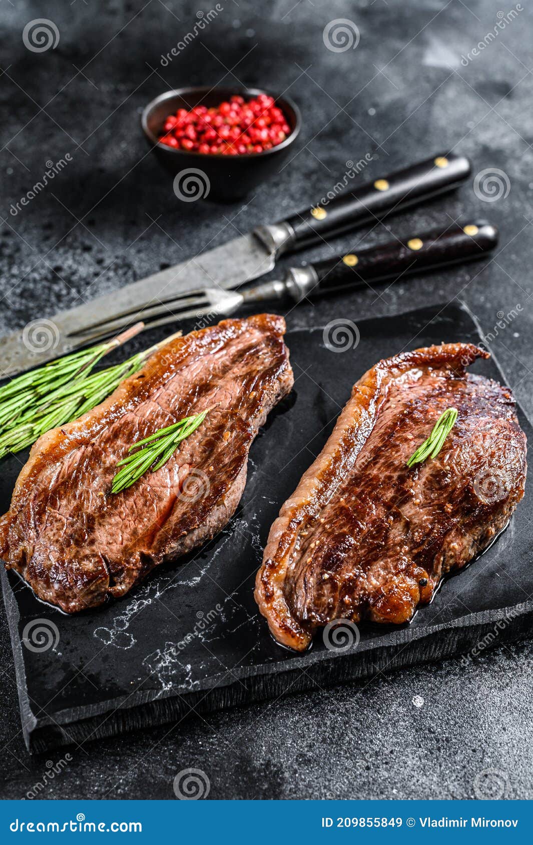 Grilled Ramp Cap Steak on a Stone Chopping Board. Black Background ...