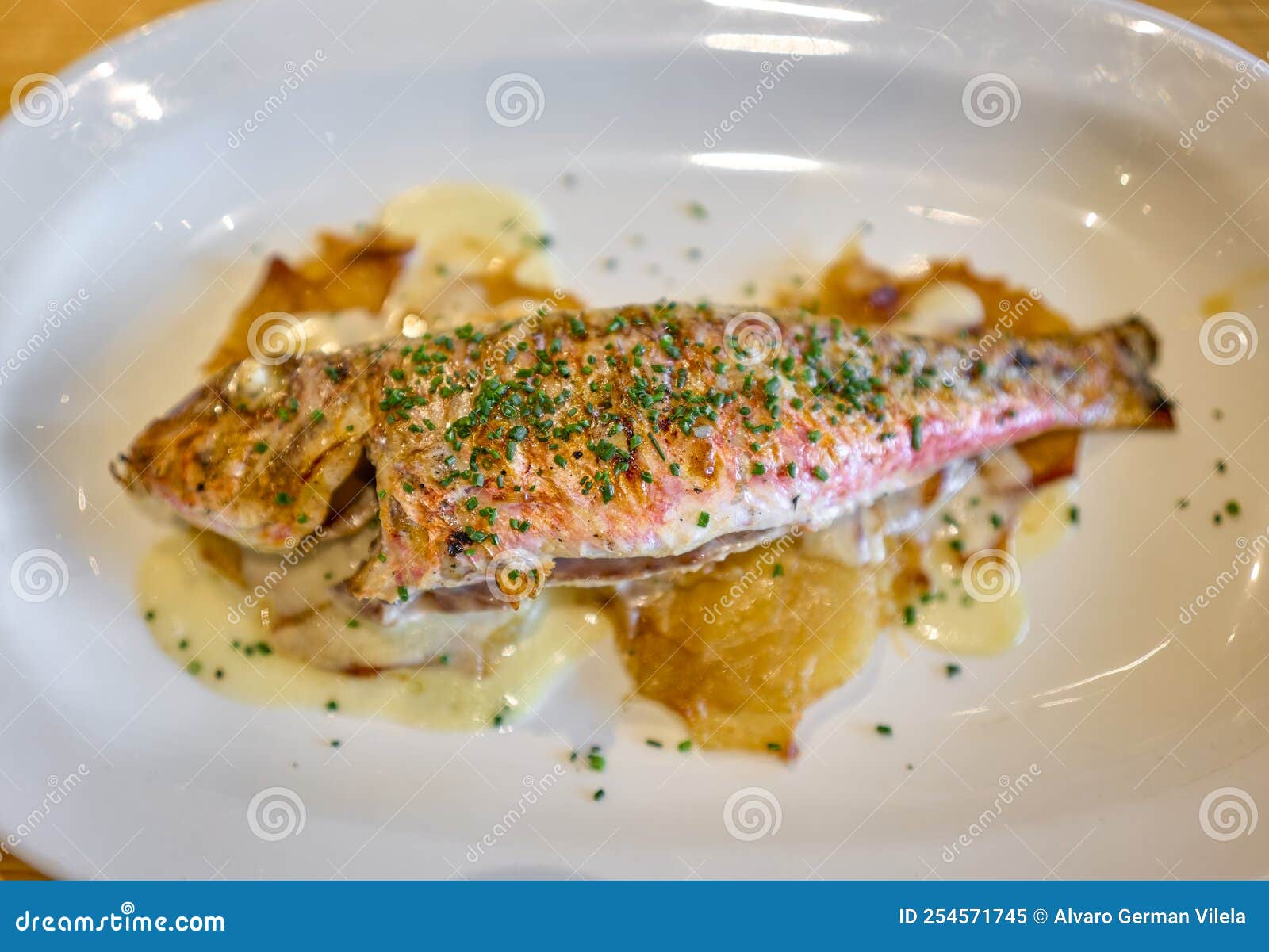 Grilled Red Mullet Serverd Over Baked Potatoes Stock Image - Image of ...