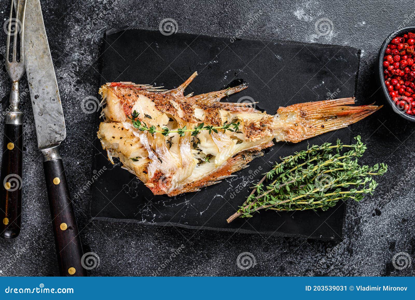 Grilled Red Sea Perch on a Cutting Board. Black Background Stock Image ...