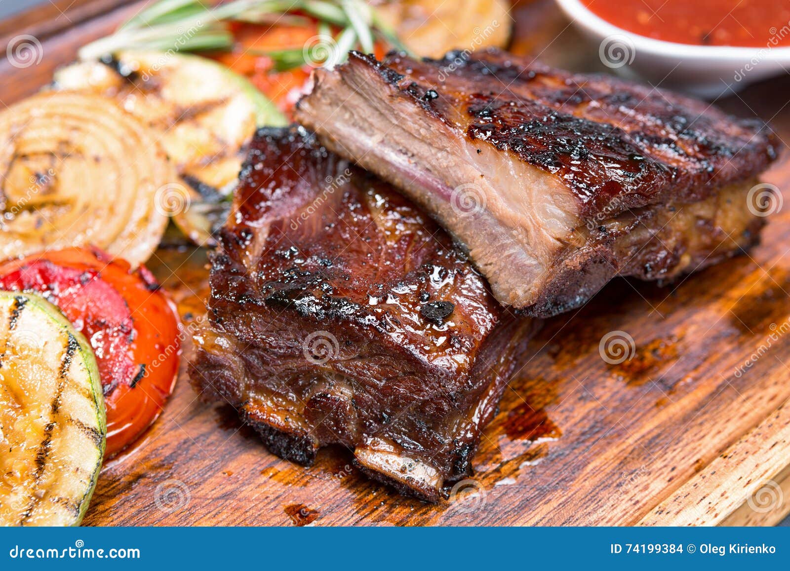 Grilled Ribs on a Wooden Board with Vegetables Stock Photo - Image of ...