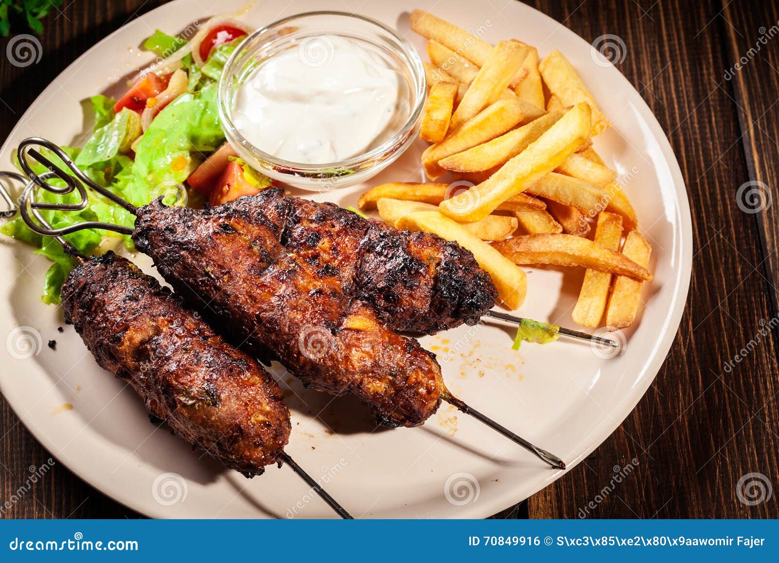 Grilled Shish Kebab Served with Fried Chips and Salad Stock Photo ...