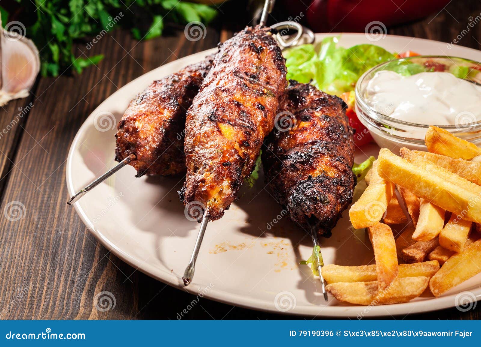 Grilled Shish Kebab Served with Fried Chips and Salad Stock Photo ...