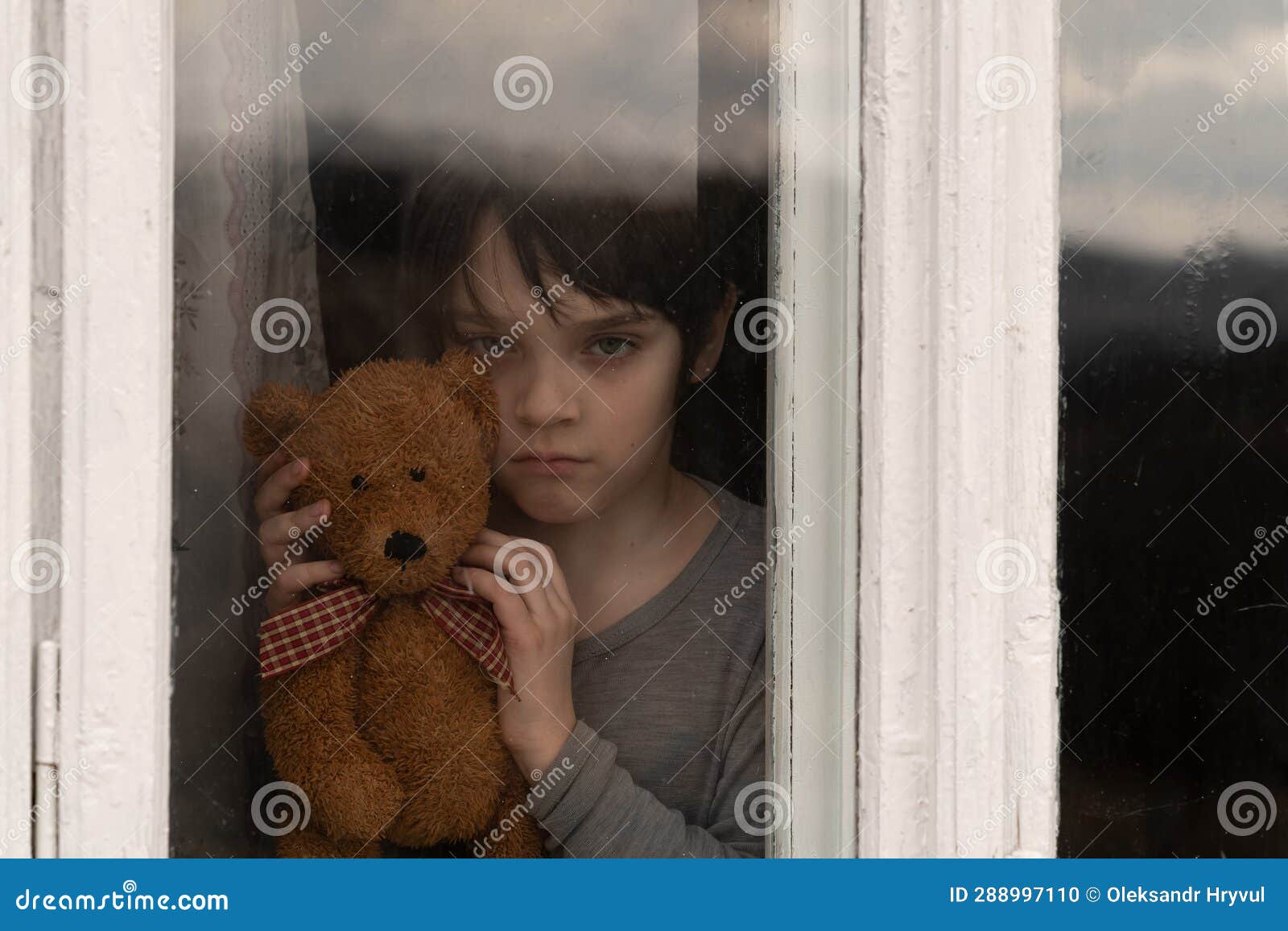 Grimy Boy Looking through a Dirty Old Window. he is Holding a Brown ...