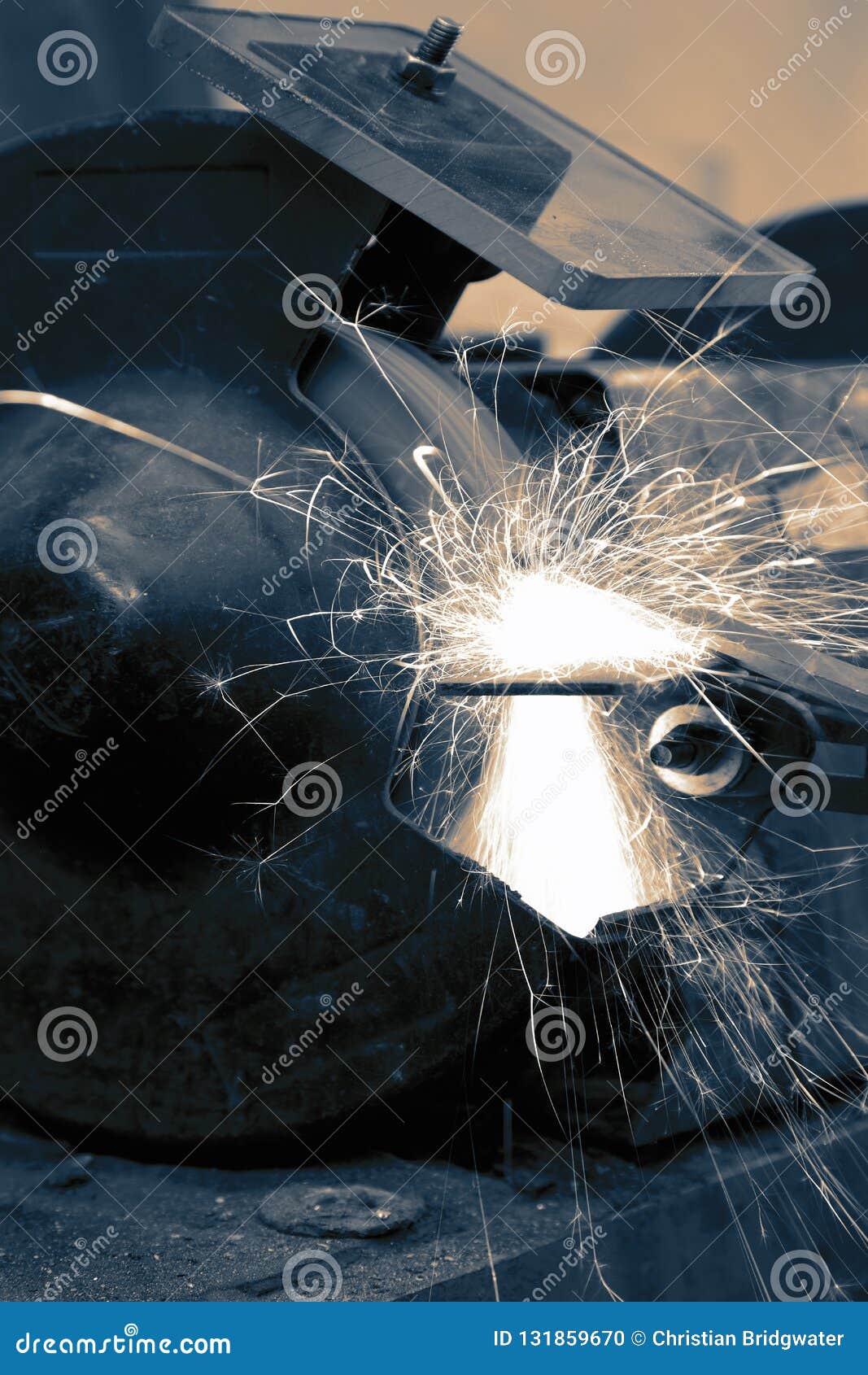 Grinding Metal with an Electric Grinder Machine with Sparks in a ...