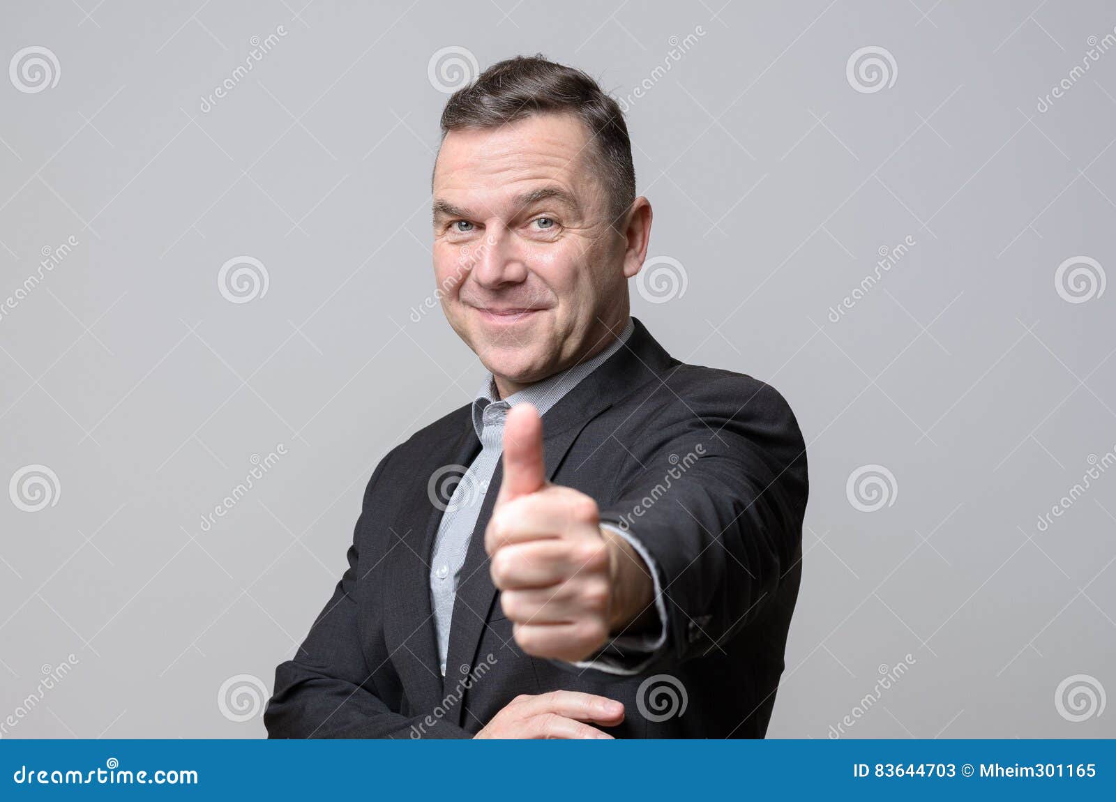 Grinning Man in Suit with Thumb Up Stock Image - Image of smiling ...