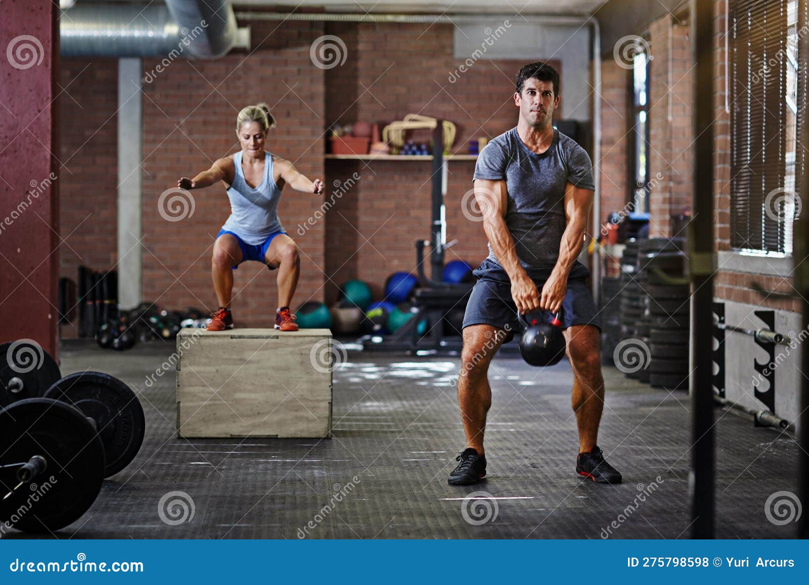 Grip this Workout and Rip it. Two People Working Out with Kettlebells ...