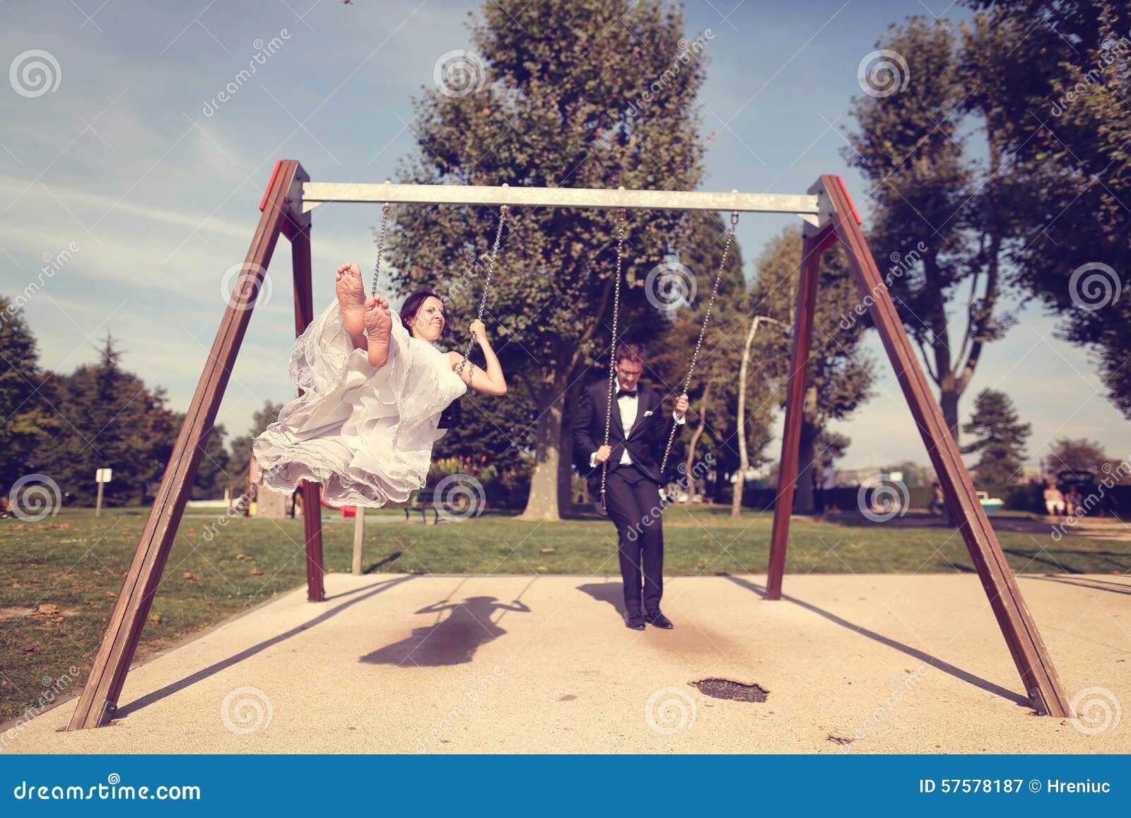 Groom and Bride Having Fun on a Swing Set Stock Image - Image of swing ...