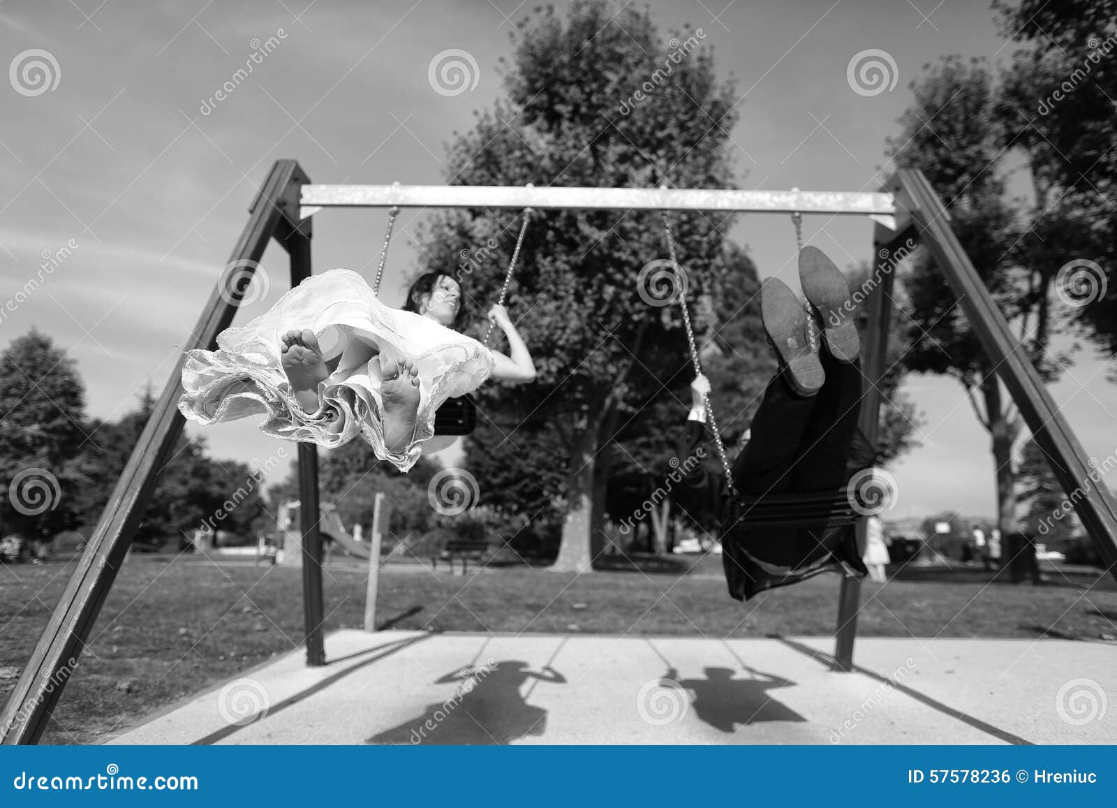 Groom and Bride Having Fun on a Swing Set Stock Photo - Image of people ...