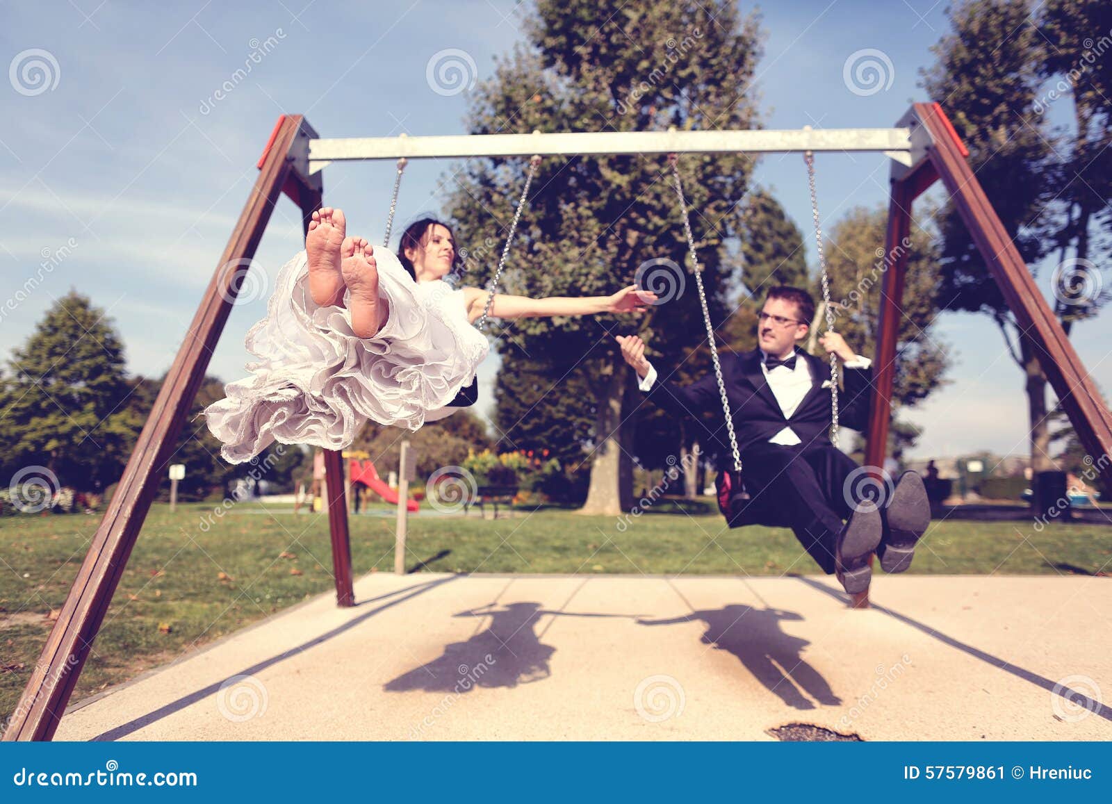 Groom and Bride Having Fun on a Swing Set Stock Image - Image of blonde ...