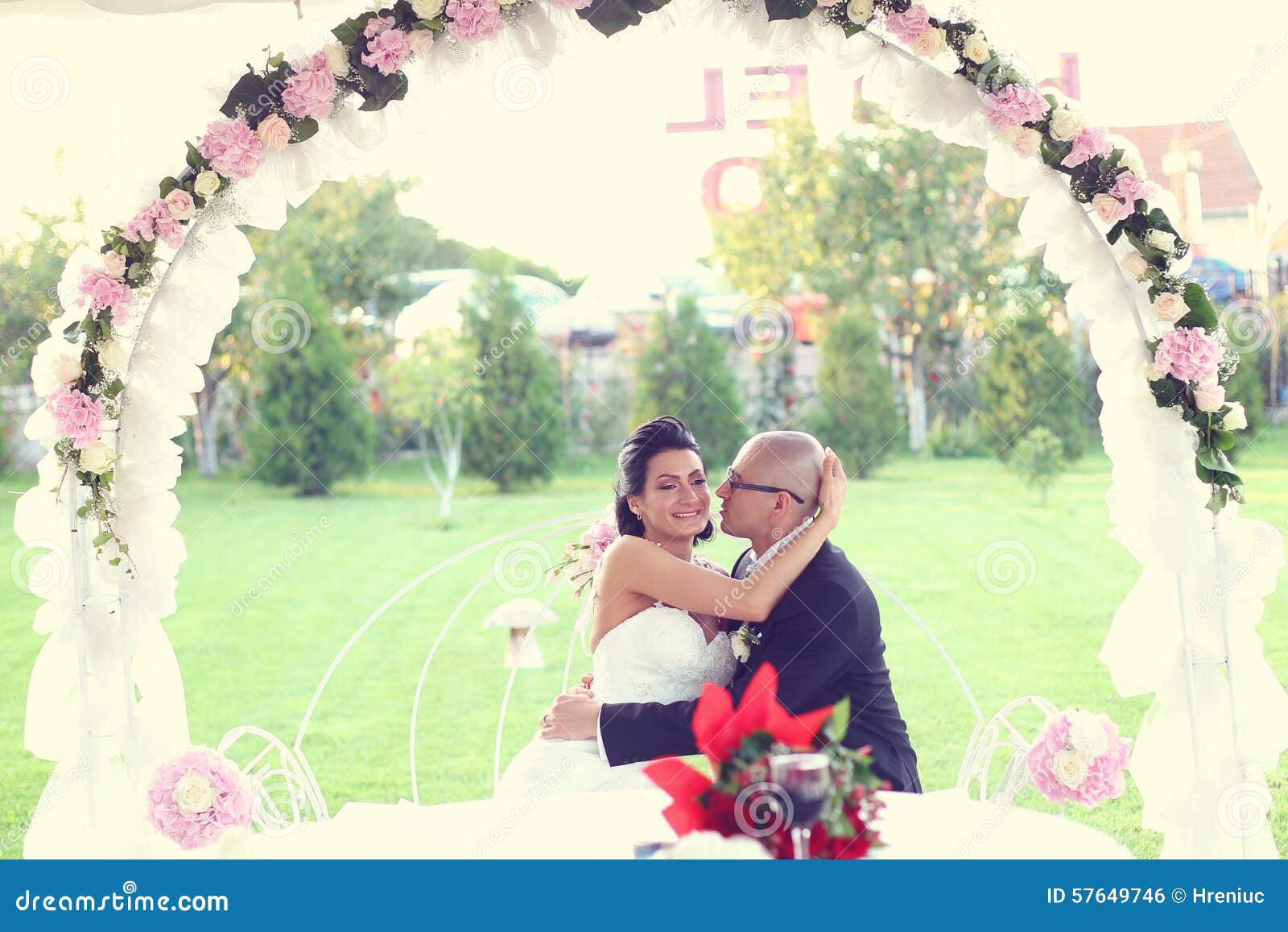Groom and Bride Sitting on a Bench in the Garden Stock Photo - Image of ...
