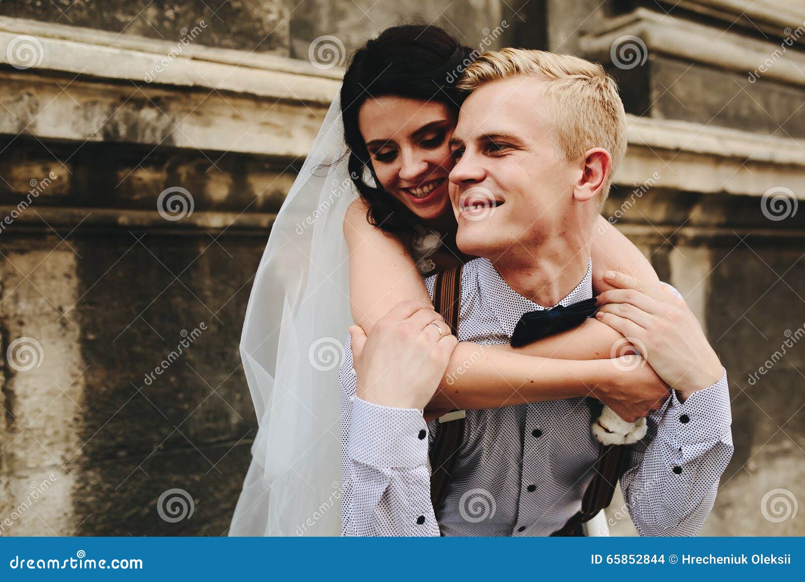 Groom Carries Bride on His Back Stock Photo - Image of charm, married ...