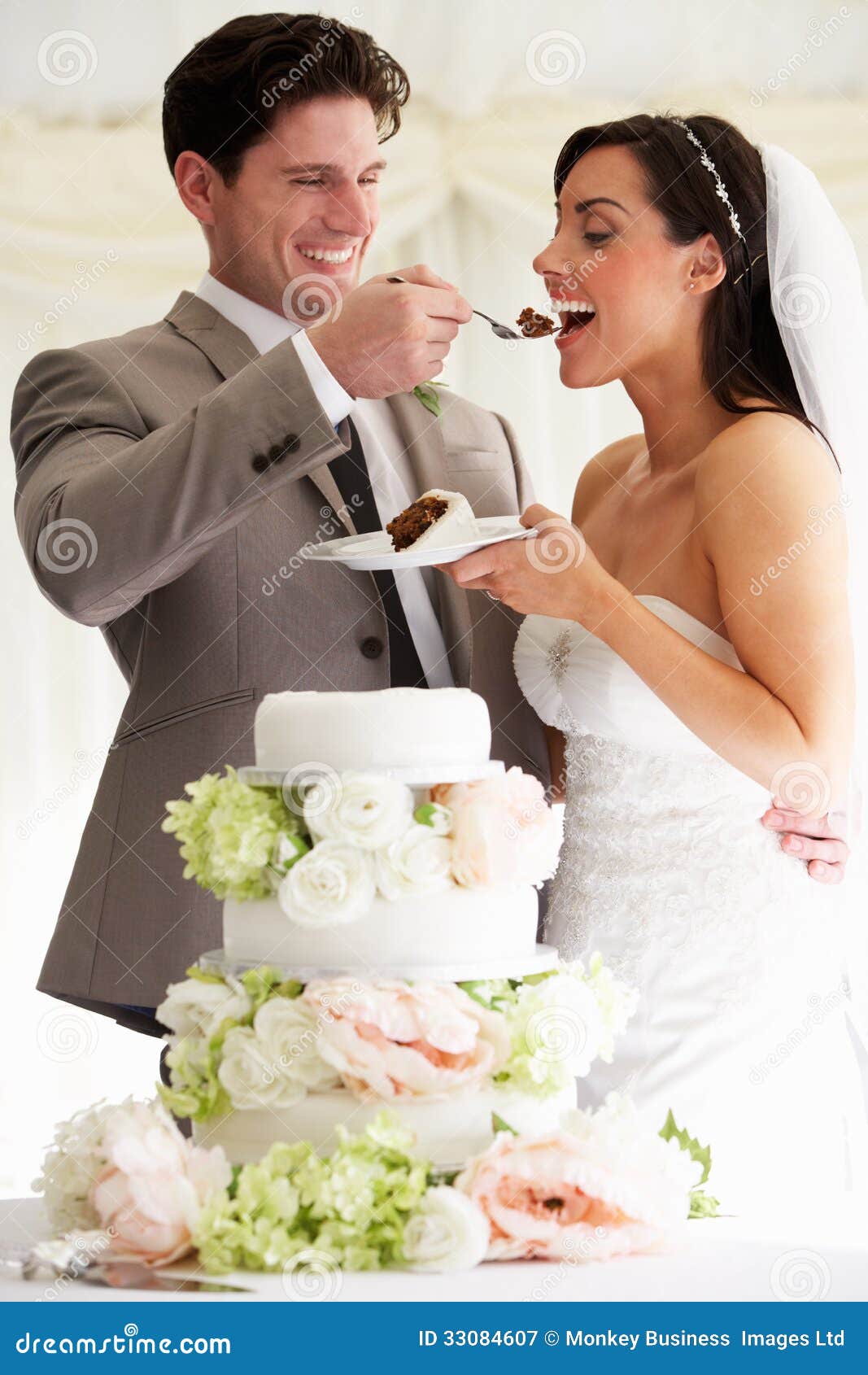 Groom Feeding Bride with Wedding Cake at Reception Stock Image - Image ...