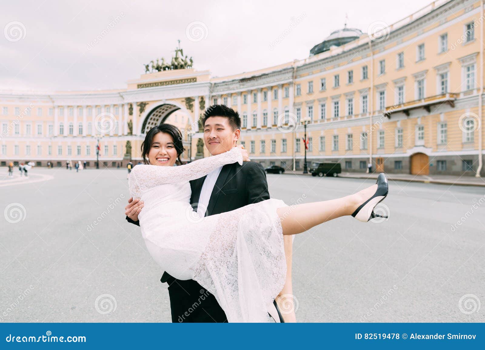 Groom holding bride stock photo. Image of emotion, building - 82519478