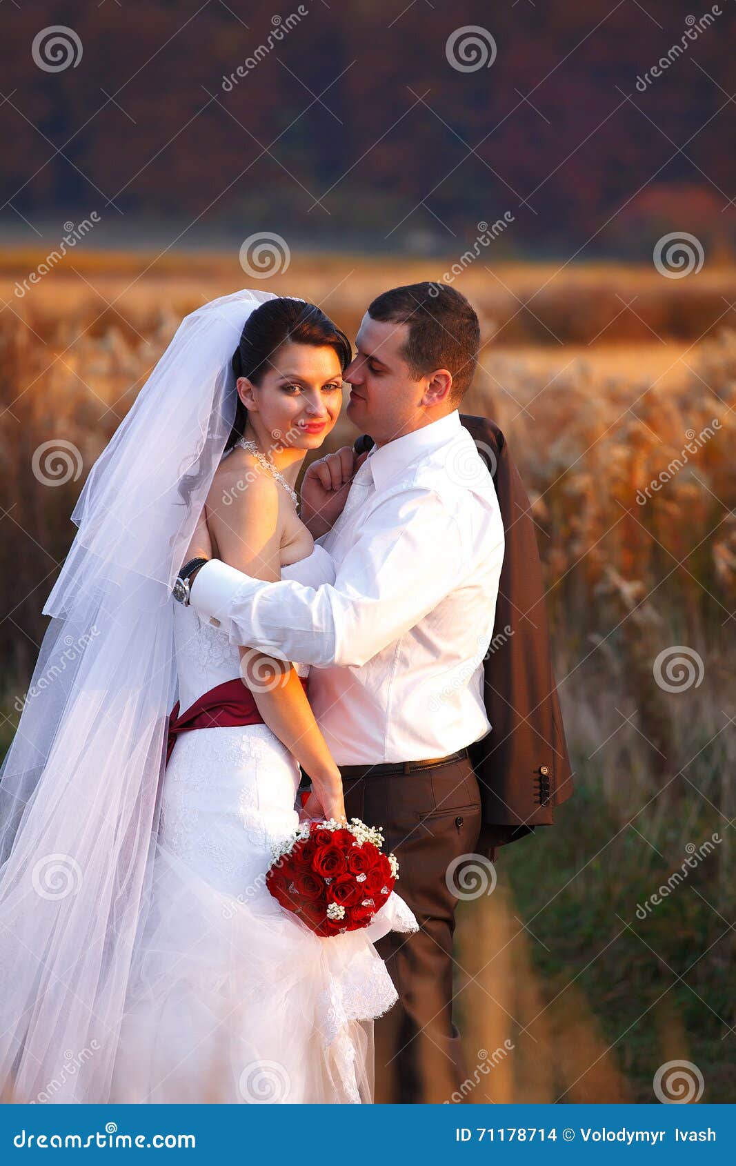 Groom Hugs a Smiling Bride Holding a Jacket Over His Shoulder Stock ...