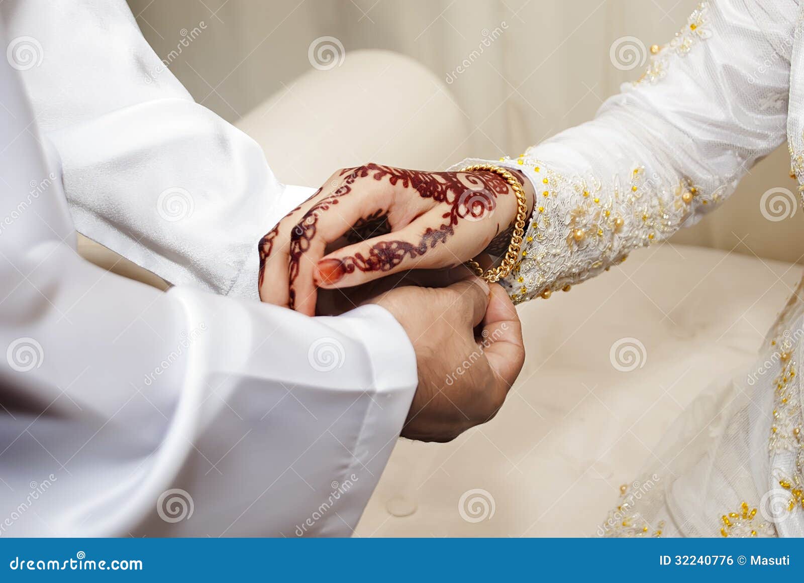 Groom Putting on a Gold Chain into the Hands of the Bride Stock Photo ...