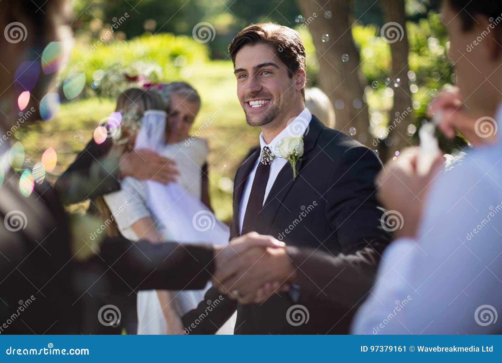 Groom Shaking Hand with Guest in Park Stock Image - Image of adult ...