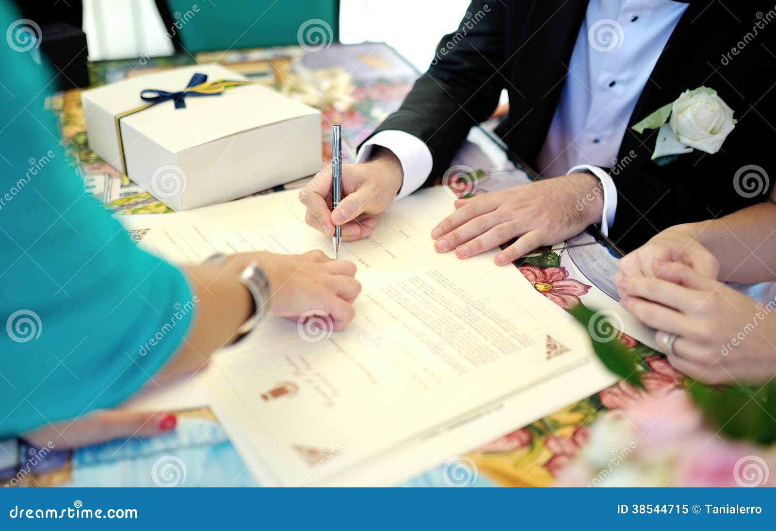 Groom signs documents stock image. Image of couple, flowers - 38544715
