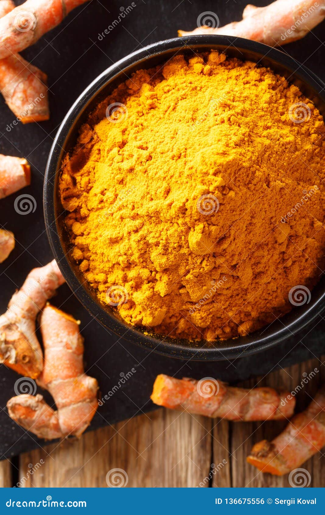 Ground Fresh Turmeric in a Bowl and Root Close-up. Vertical Top View ...