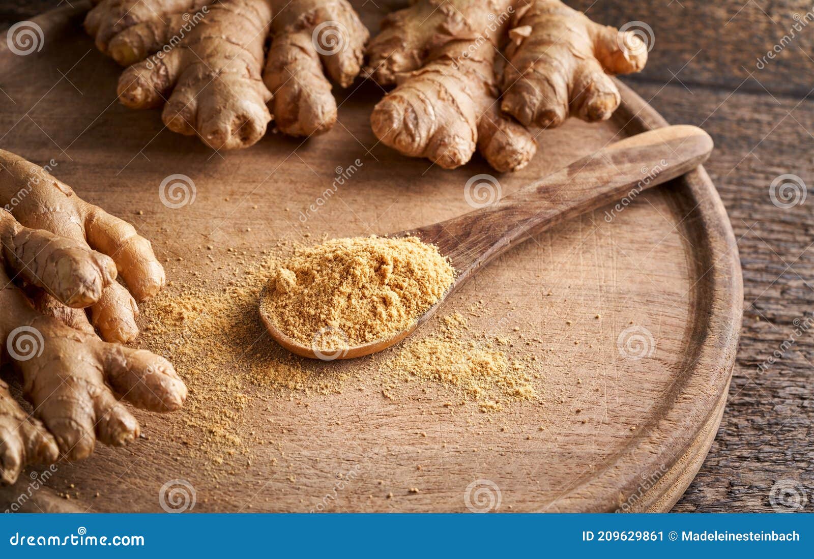 Ground Ginger on a Spoon with Fresh Ginger Root in the Background Stock ...