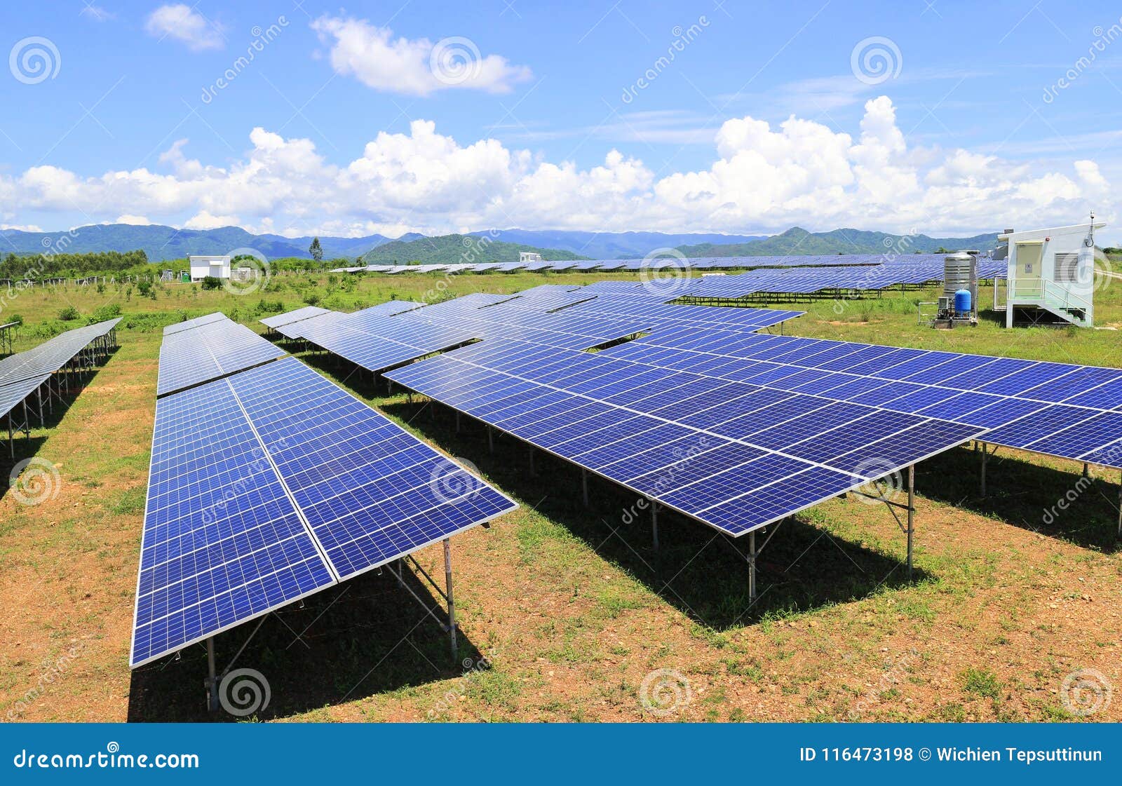 On Ground Solar Farm Under Blue and Cloudy Sky Mountain Background ...