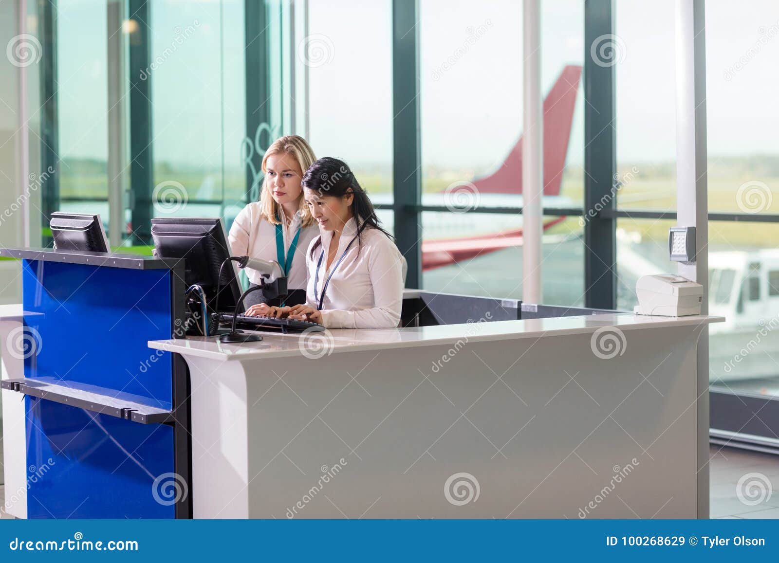 Ground Staff Using Computer at Counter in Airport Stock Image - Image ...