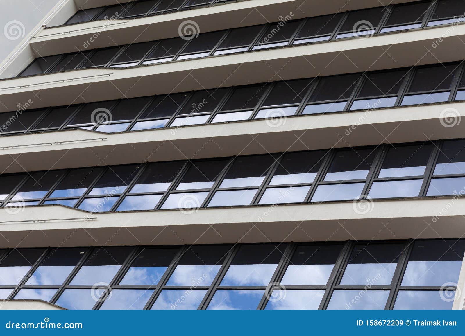 Ground View of Glass Square Windows on White Building Facade with Sky ...