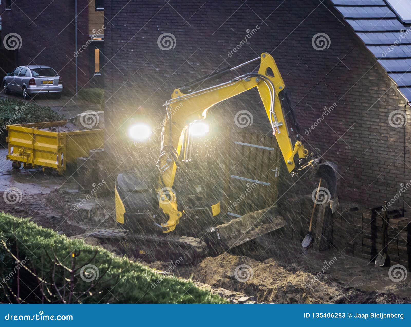 Ground Worker Working on a Garden in Bad Rainy Weather in the Evening ...