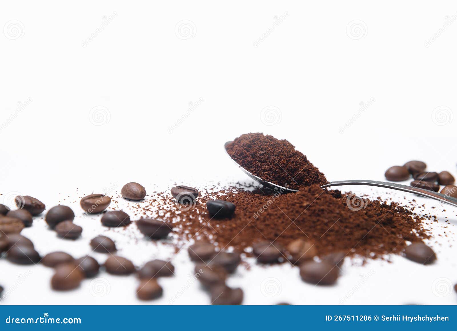 Grounded Coffee in a Spoon Surrounded with Beans Isolated Stock Photo ...