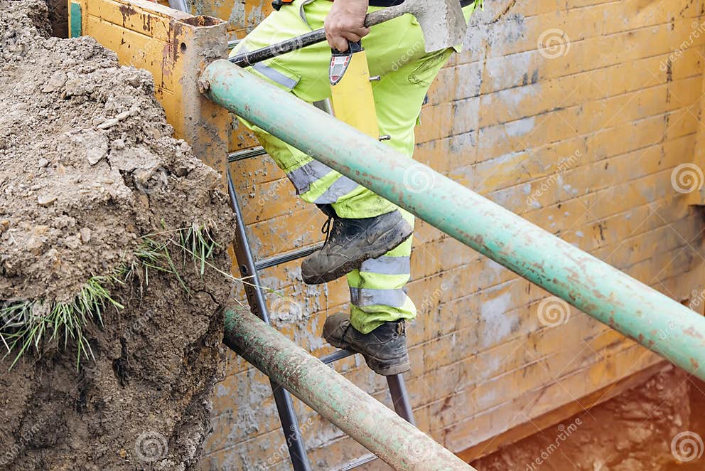 Groundworker Builder Using Steps Ladder To Get Out of Deep Drainage ...