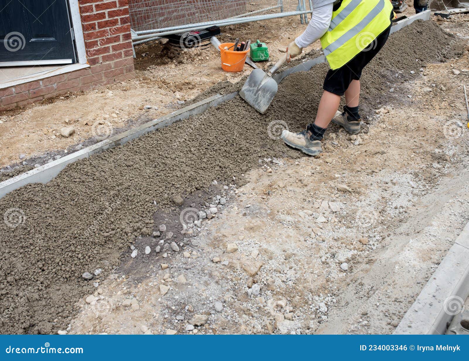 Groundworker Placing and Levelling with the Shovel a Semi-dry Concrete ...