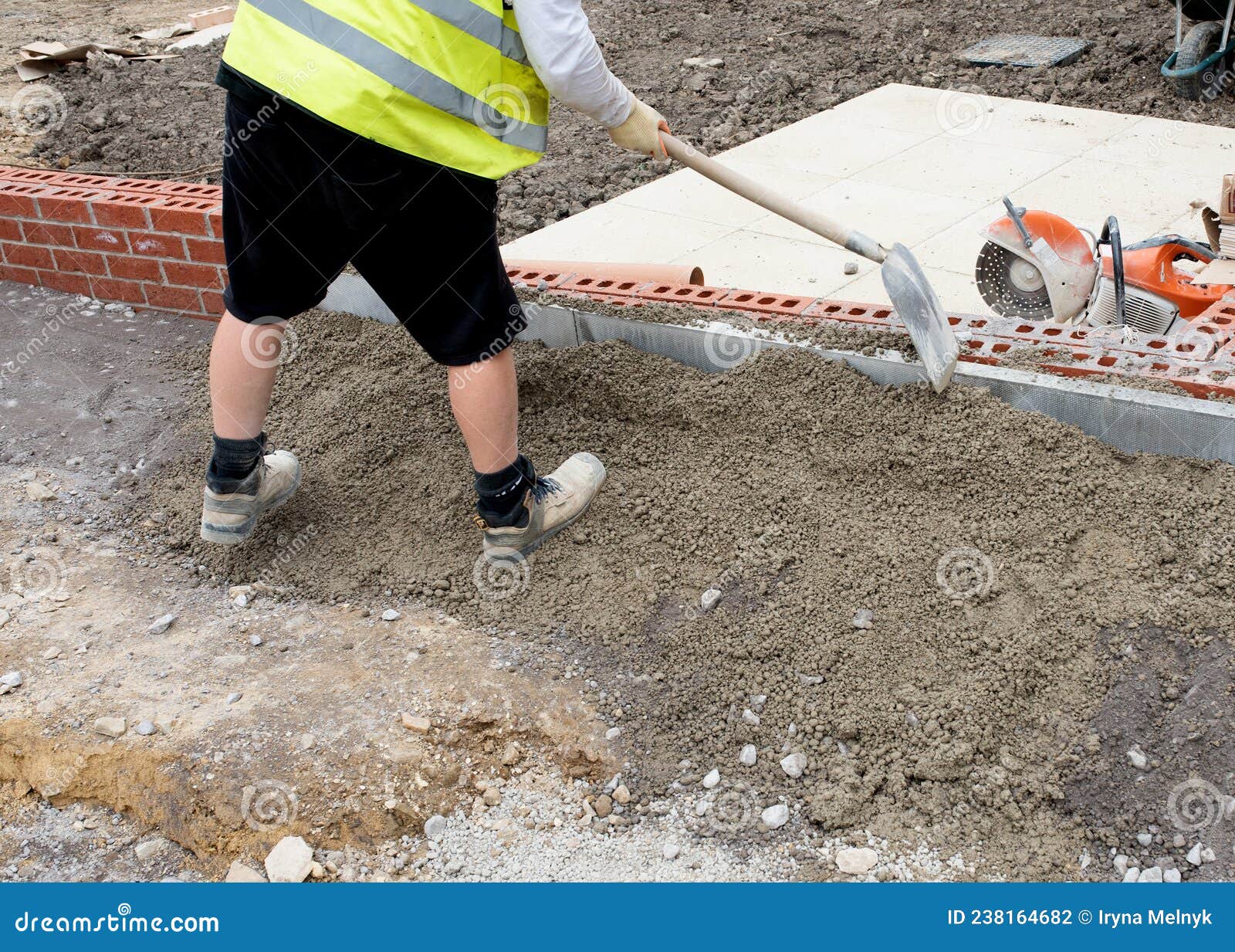 Groundworker Placing Wet Concrete Inside Formwork During Roadworks ...